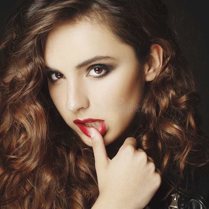 Beautiful Young Woman Posing In Black Leather Jacket Over Grey B Stock