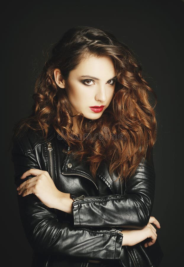 Beautiful Young Woman Posing In Black Leather Jacket Over Grey B Stock