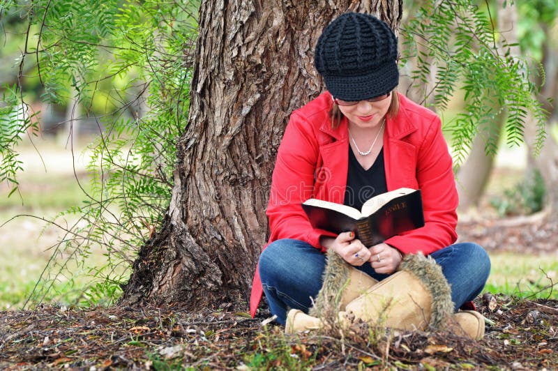 Beautiful Young Woman Reading Bible Under Big Tree Stock Image - Image ...