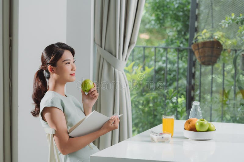 Beautiful Young Woman Reading Book during Breakfast at Home Stock Photo ...