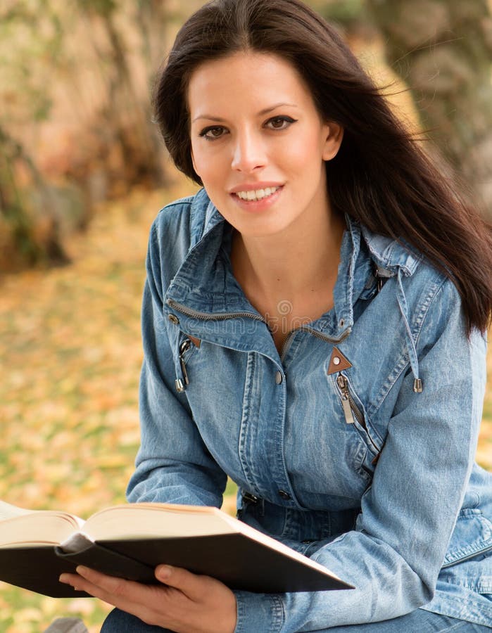 Beautiful Young Woman Reading a Book in Park at Fall Stock Image ...