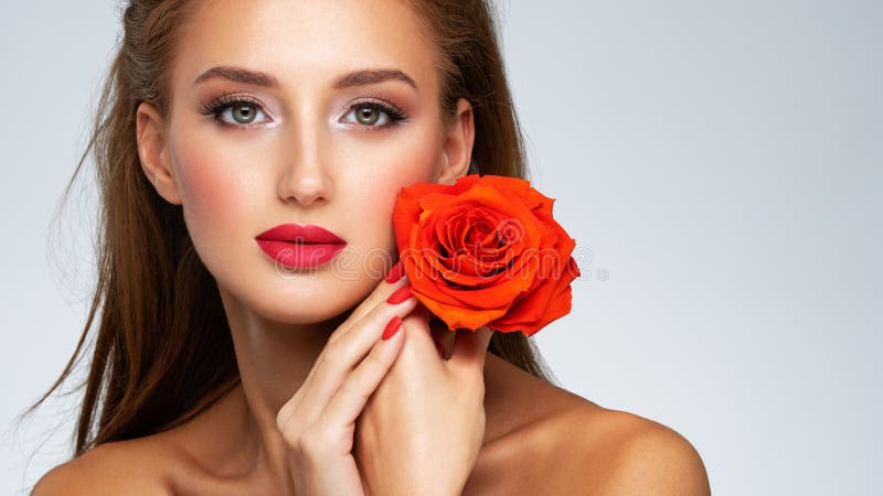 Beautiful Young Woman With A Red Flower In Hand Near Face Portrait Of