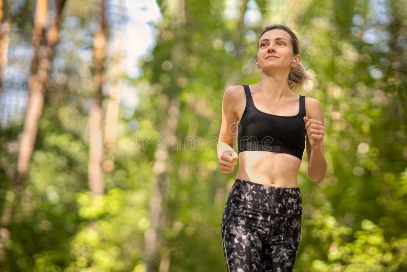 Beautiful Young Woman Runner in a Green Forest Stock Image - Image of ...