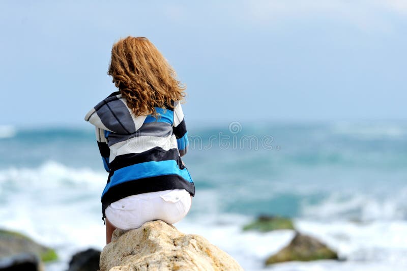 Young Woman Sitting on the Stone on the Seashore Stock Photo - Image of ...