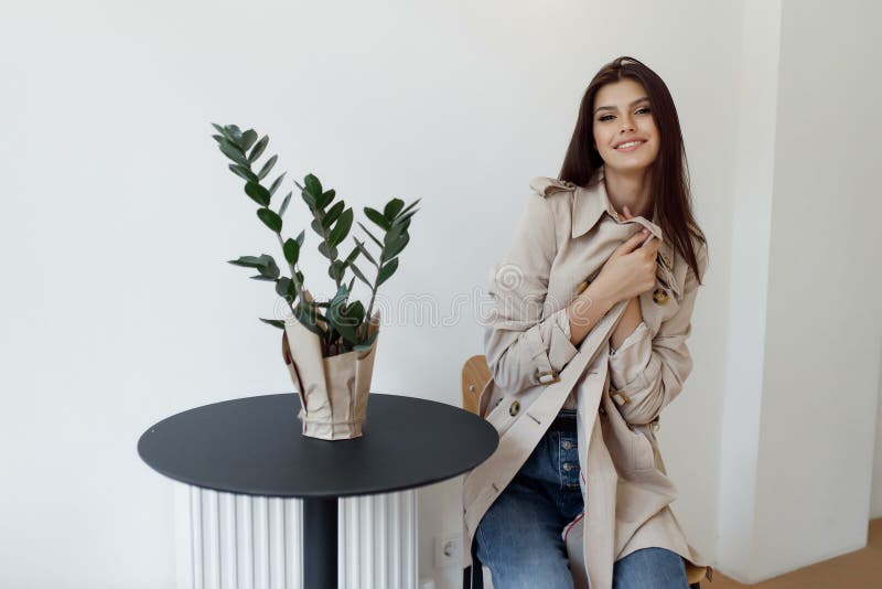 Beautiful Young Woman Sitting at a Table and Smiling Stock Photo ...