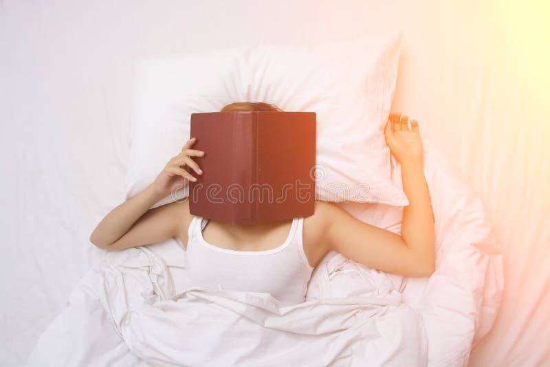 Beautiful Young Woman Sleeping on the Bed after Read a Book with Stock ...