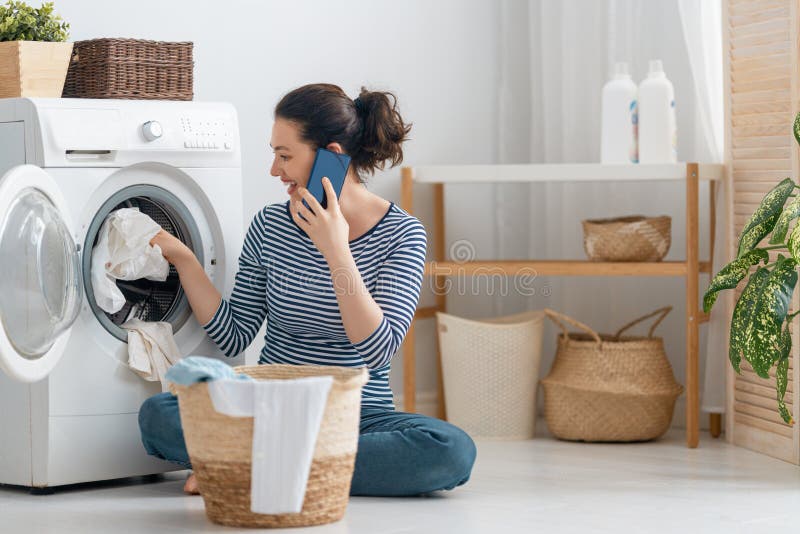 Woman is doing laundry stock image. Image of hold, clothes - 198037711