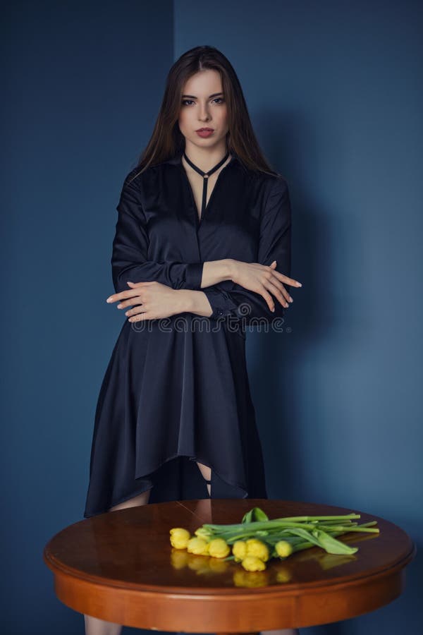 Beautiful Young Woman Stands Behind the Table with Tulips. Stock Image ...