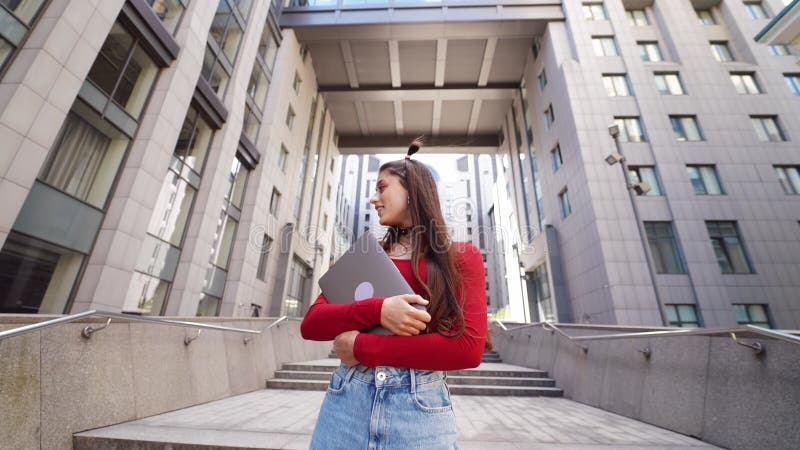 Young Woman with a Laptop Walking on the Street Stock Footage - Video ...