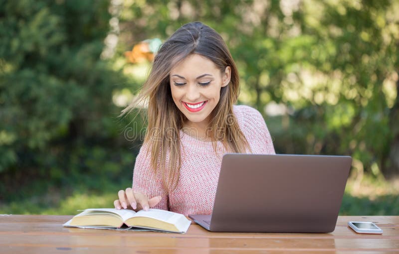 Beautiful Young Woman Studying in a Park Stock Photo - Image of ...