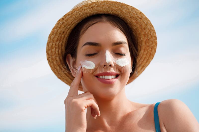 Beautiful Young Woman With Sun Cream On Face Girl Holding Sunscreen