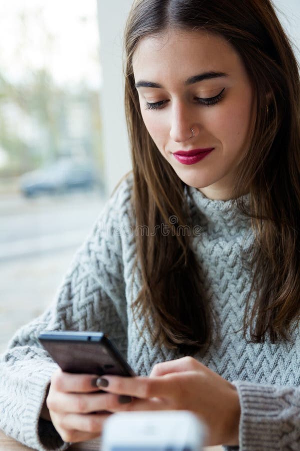 Beautiful Young Woman Using Her Mobile Phone in Coffee. Stock Image ...