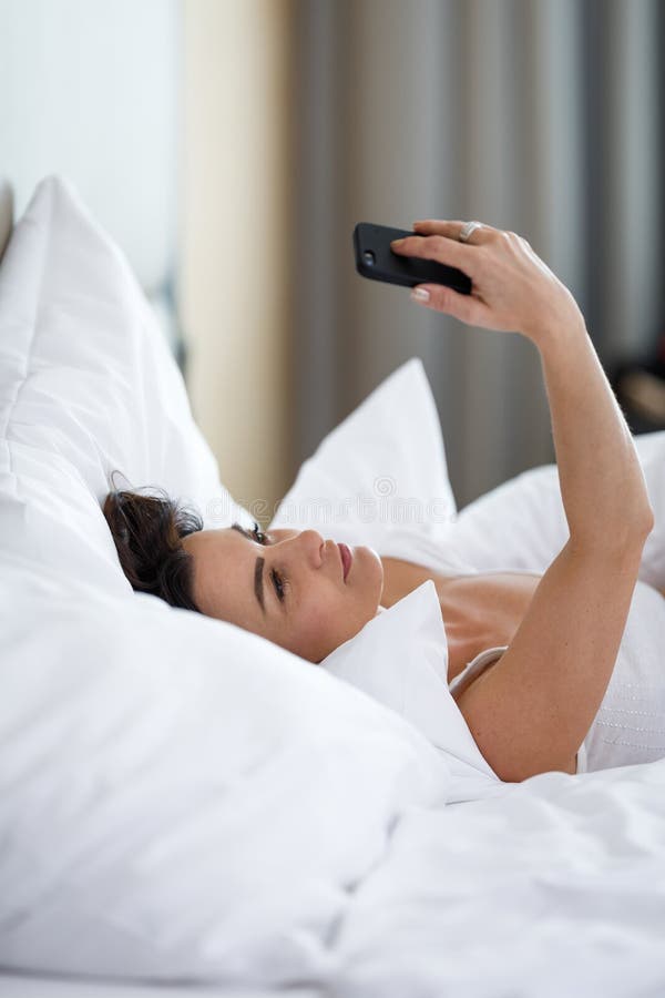 Beautiful Young Woman Using Her Smart Phone in Bed Stock Image - Image ...