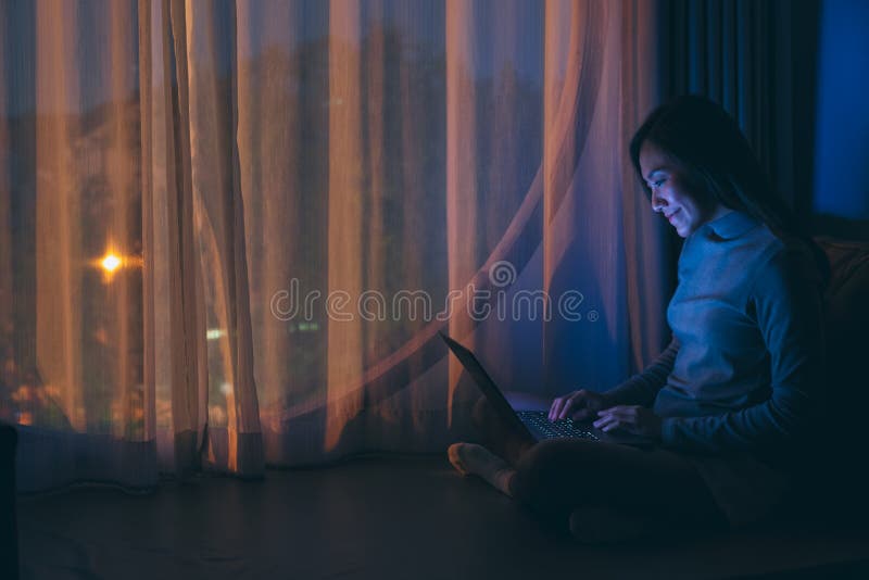 A Young Woman Using and Working on Laptop Computer with Bright Light ...