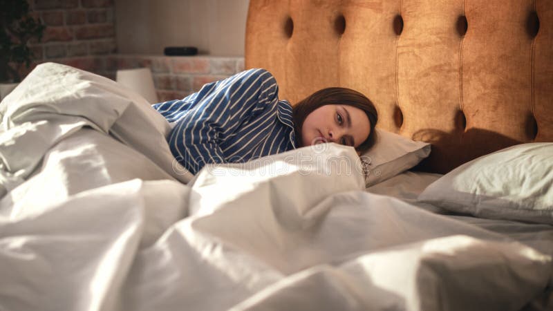 Beautiful Young Woman Waking Up In The Morning Stretches And Gets Out