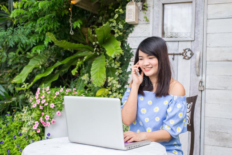 Beautiful Young Woman Working on Computer and Talking on Phone Stock ...