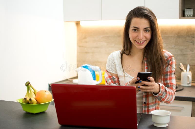 Beautiful Young Woman Working on Computer and Using Smartphone Stock ...