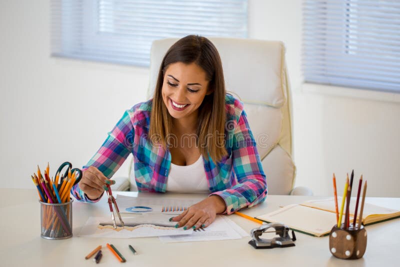 Beautiful Young Woman Working at the Office with a Drawing Compass ...