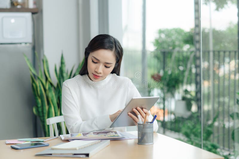 Beautiful Young Woman on the Workplace Using a Digital Tablet Stock ...