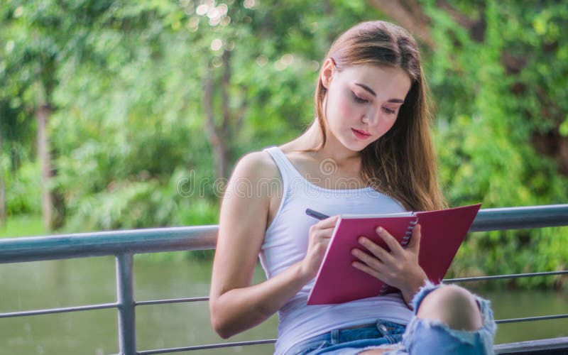 Beautiful Young Woman Writing into Her Diary, in the Garden Stock Image ...