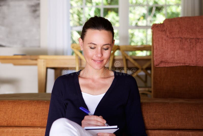 Beautiful Young Woman Writing on Note Pad at Home Stock Photo - Image ...