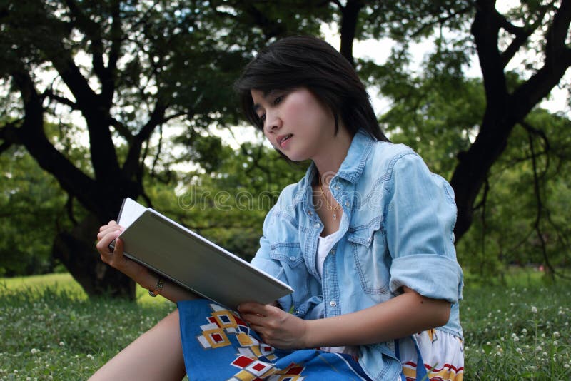 Beautiful Young Woman Writing Outdoors in a Park Stock Image - Image of ...