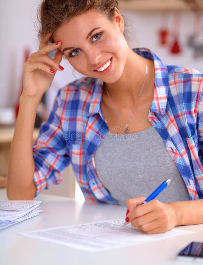 Beautiful Young Woman Writing Something in Her Note Pad Stock Photo ...