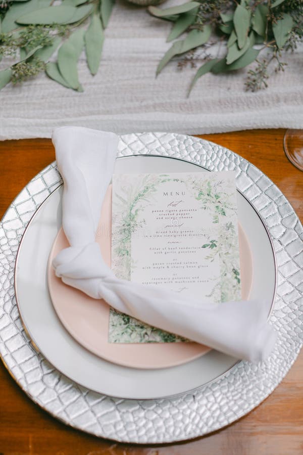 Elegant Table Setting with Green Floral Menu and White Napkin at a ...