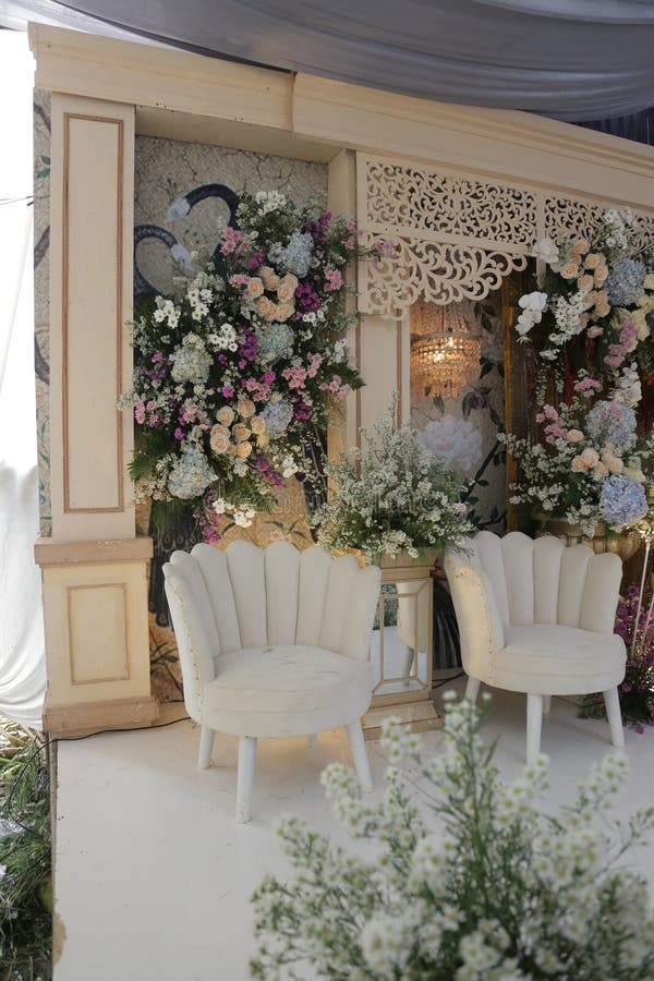 Elegant Wedding Reception Setup with Floral Decorations and Chairs ...