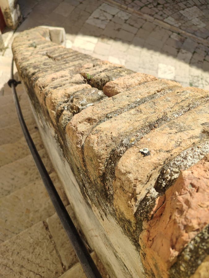 A Beautifully Designed Textured Stone Wall with Railing Showcases ...
