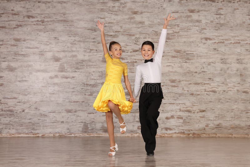 Beautifully Dressed Couple of Kids Dancing Together in Studio Stock ...