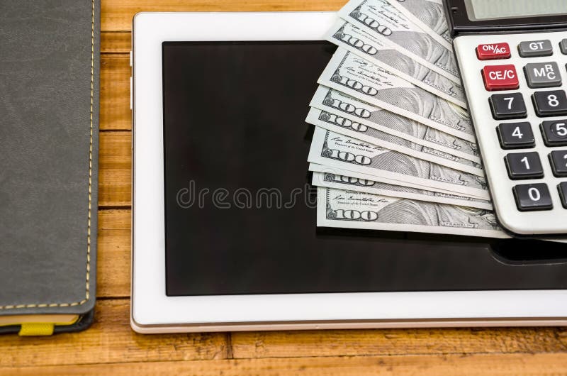 Beautifully Folded Dollars on a Tablet, Calculator and Notebook Stock ...