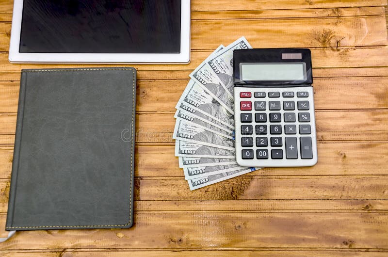 Beautifully Folded Dollars on a Tablet, Calculator and Notebook Stock ...