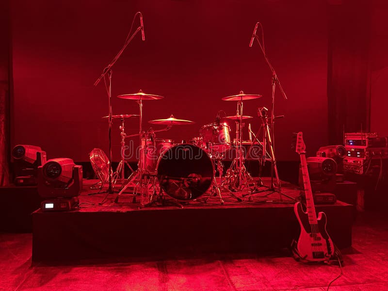 A Beautifully Illuminated Stage Setup Featuring Both Drums and Guitar ...