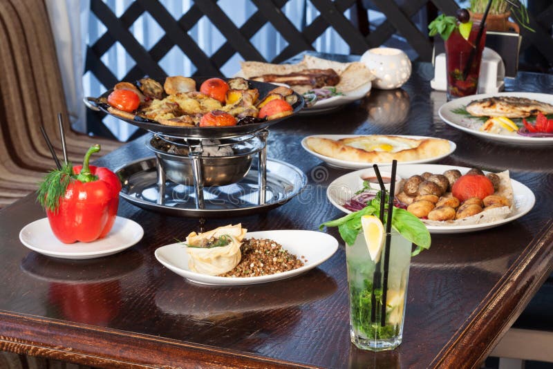 Beautifully Set Table with a Different Meal Stock Photo - Image of herb ...