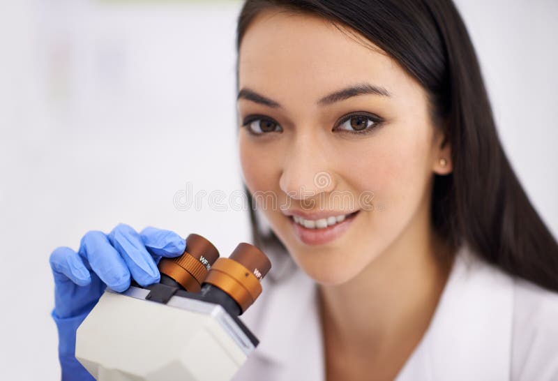 Beauty and Intellect. Portrait of a Female Scientist Using a Microscope ...