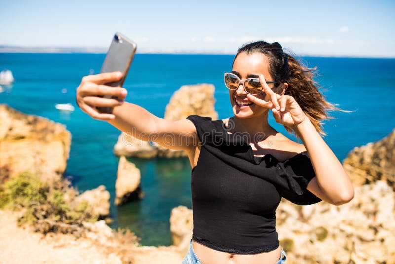 Beauty Latin Woman Take Selfie From Phone At The Top Of Beautiful Cliff