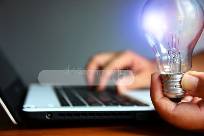 Beauty Light Bulb in Left Hand while Light Hand Using Laptop with ...