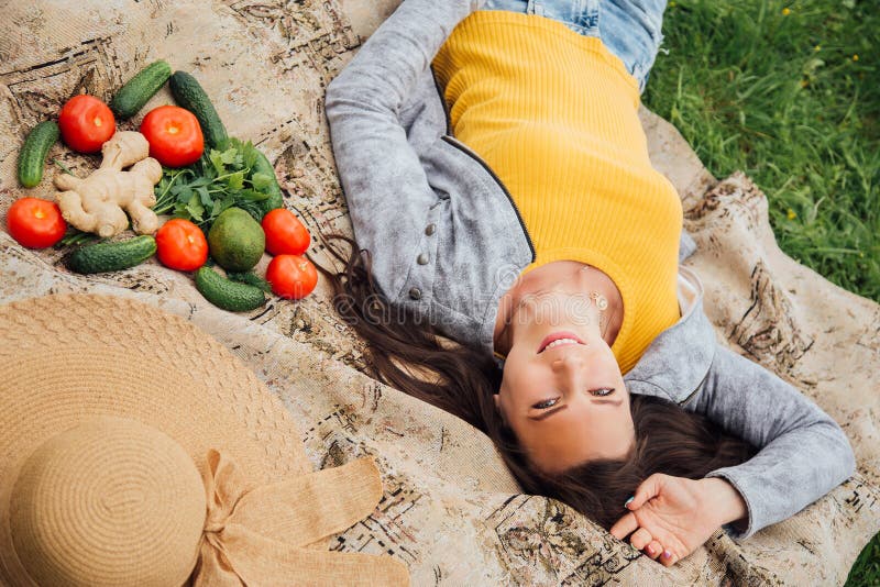 Beauty Portrait Of A Woman Surrounded By Various Healthy Food Lying On