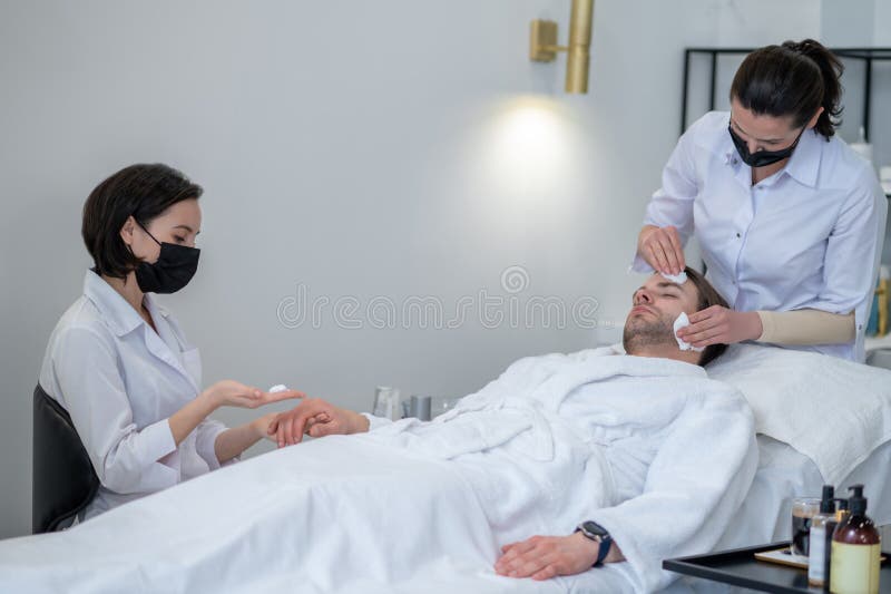 Two Professionals Working with the Client in the Beauty Salon Stock ...