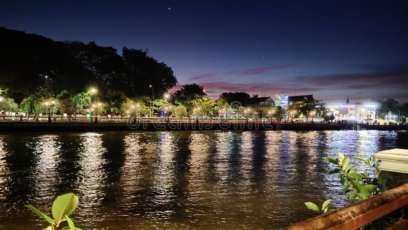 The Beauty of the River on the Outskirts of Town Illuminated by Lights ...