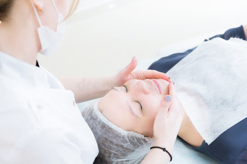 Beauty Saloon Close Up Of A Medical Beautician In Pink Gloves Makes A