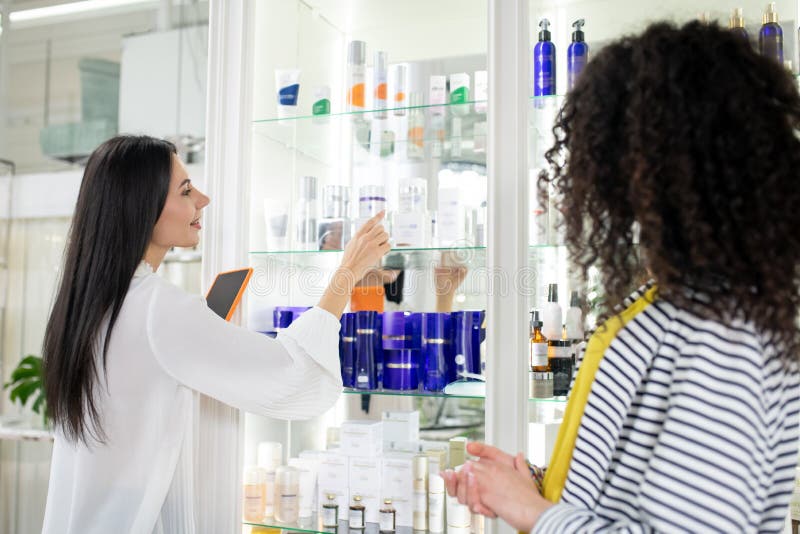 Beauty Shop Assistant Getting New Products from the Shop-window Stock ...