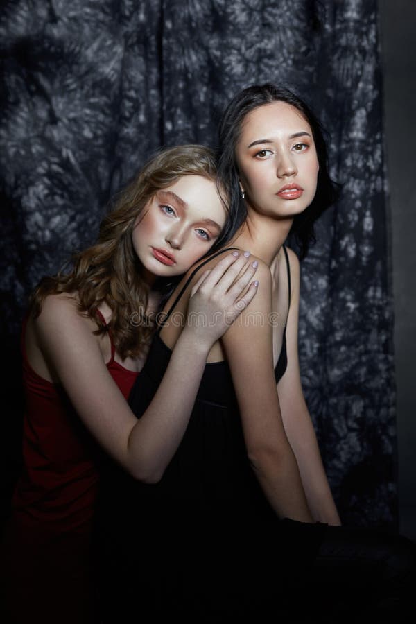 Beauty Spring Portrait Of Two Girls On A Dark Background Women Hug And