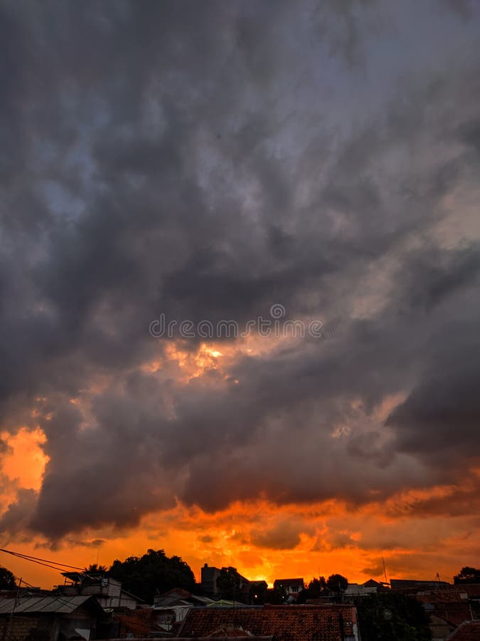 The Beauty of Sunset Hidden Behind the Clouds Stock Photo - Image of ...