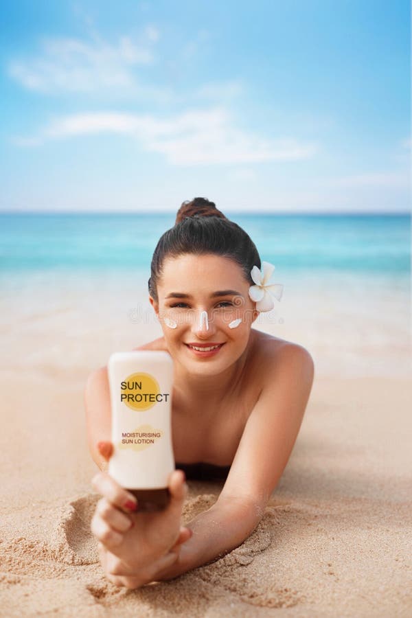 Beauty Woman In Bikini Holding Bottles Of Sunscreen In Her Hands