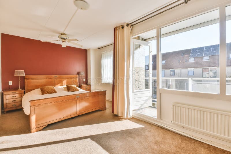 Bed and Bedside Table Near Window Stock Photo - Image of residence ...