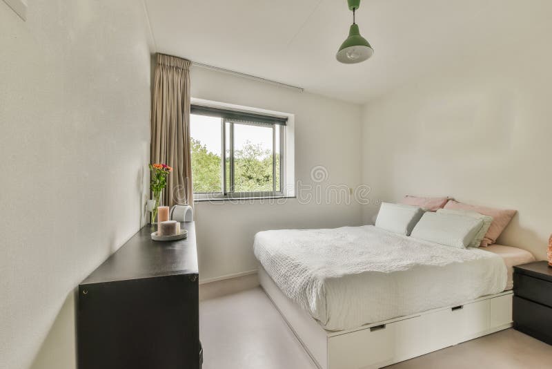 Bed and Bedside Table Near Window Stock Photo - Image of minimal ...