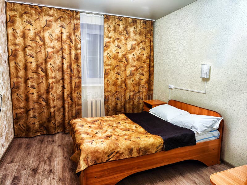 Bed in a Cozy Hotel Room. Background with Room of Small, Poor Hotel or ...