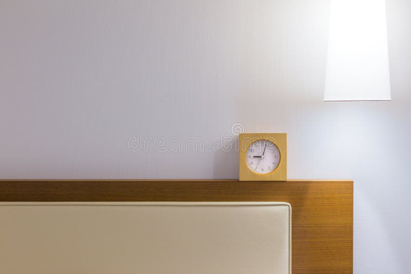Bed Headboard, White Pillow, Small Clock, and Over Head Lamp, Stock ...